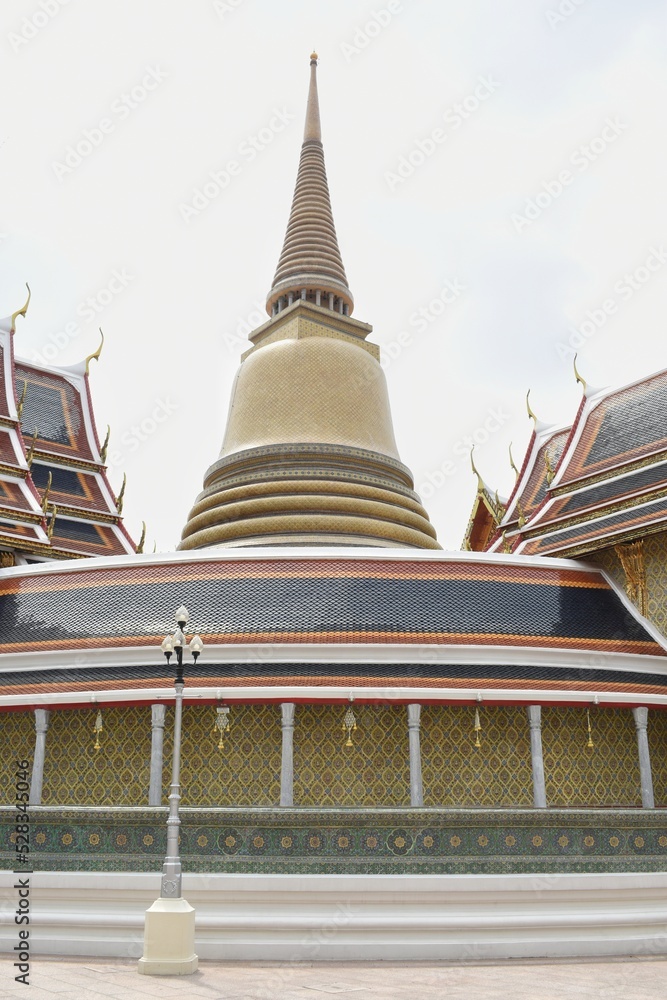 Golden pagoda and the curved walkway around the circular cloister of ...