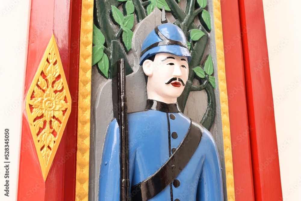 The entrance with an image of watchman in Wat Ratchabophit, The temple ...