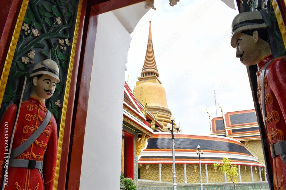 The entrance with an image of watchman in Wat Ratchabophit, The temple ...