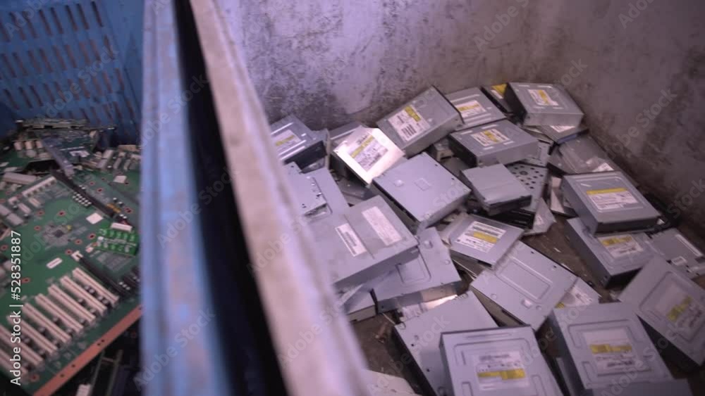 Right panel between a bin with used motherboards and a container with ...