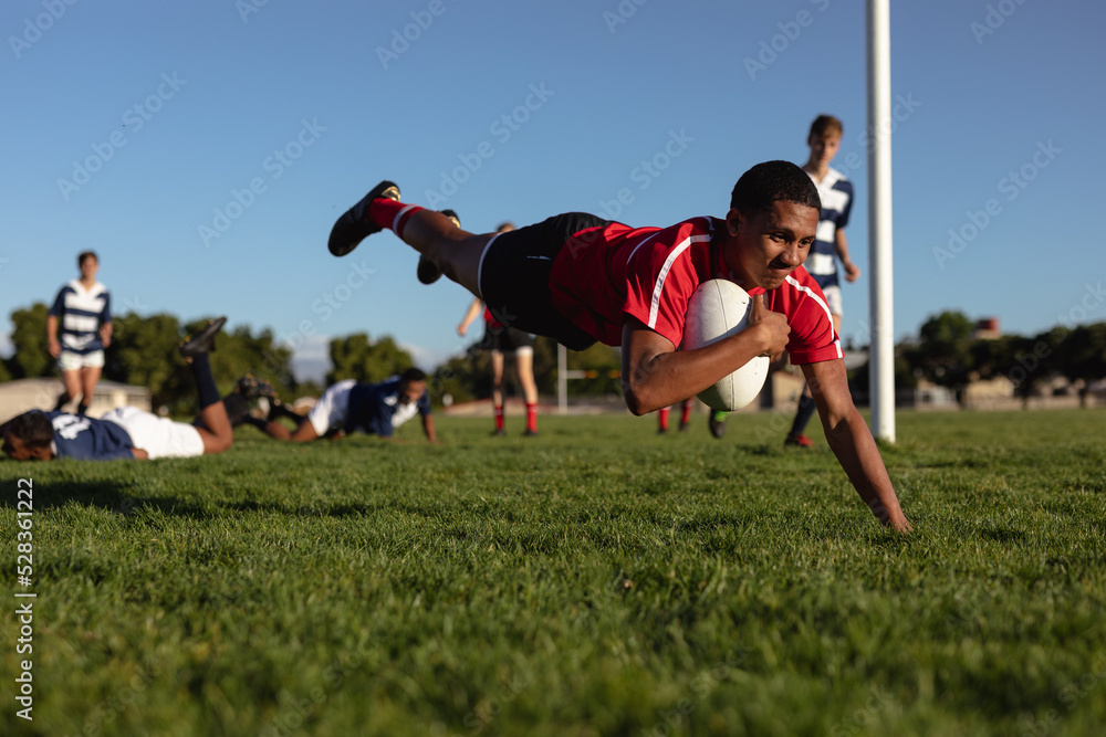 Rugby player jumping and scoring an try Stock Photo | Adobe Stock
