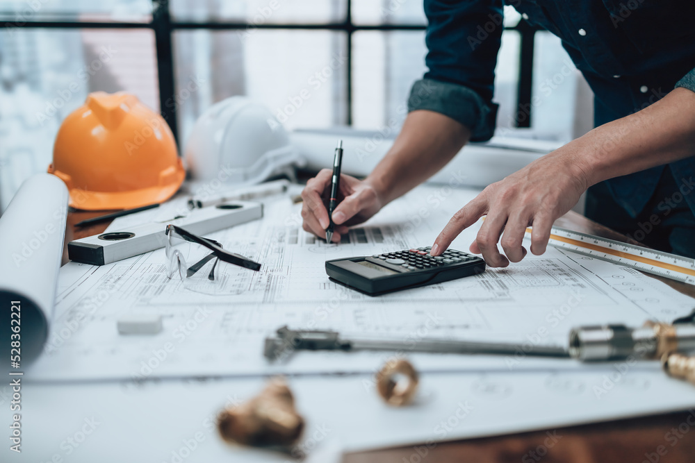 Engineering working with drawings inspection and writing on the office ...