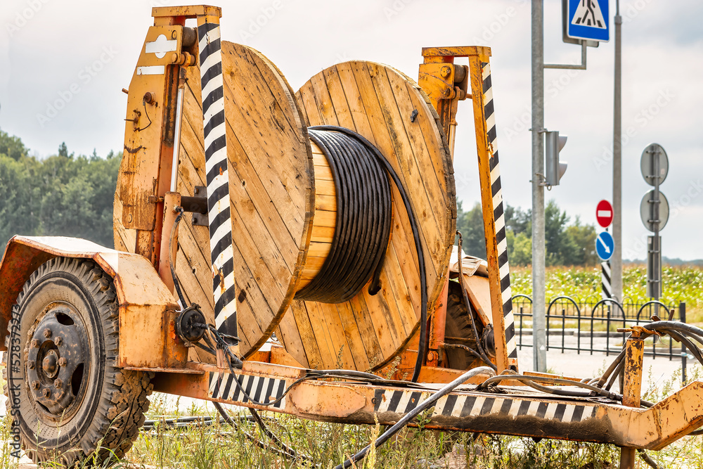 Wooden reel with high voltage cable mounted on a trailer for easy ...
