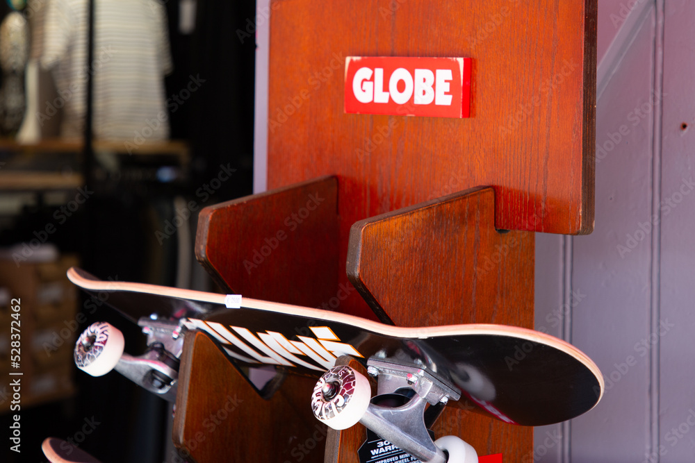 globe logo sign and brand text on display skate board store facade ...