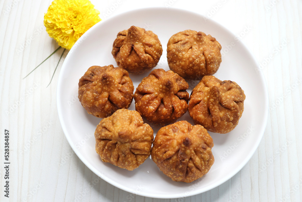 Fried Modak. It's a traditional sweet dish of coconut, jaggery, and dry ...