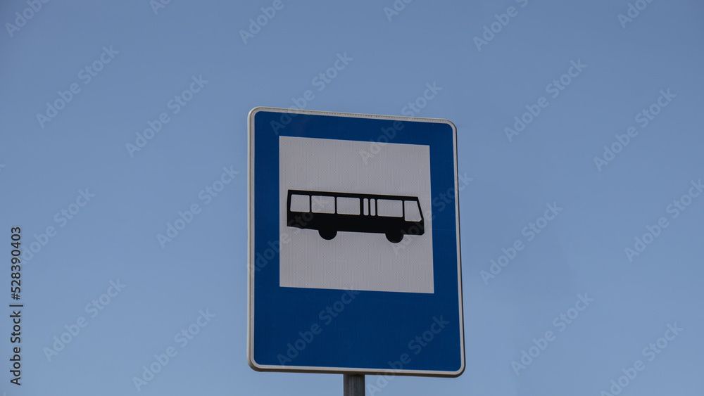 Blue and white bus stop sign in Europe with sky background. Bus stop ...