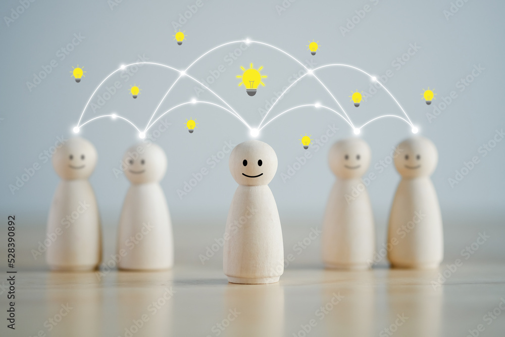 Idea. Teamwork. Happy wooden person figure standing with team and they ...