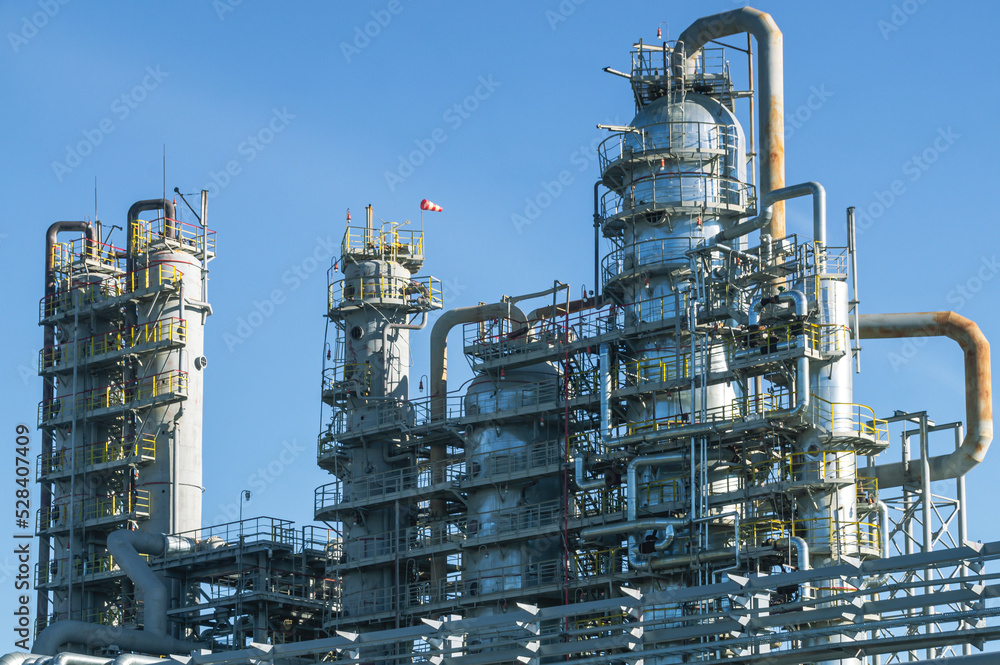 Fractionating column at an oil refinery. Production equipment at a ...