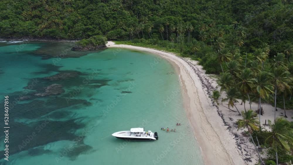 Flyover yacht boat anchored at Playa El Ermitano beach over pristine ...