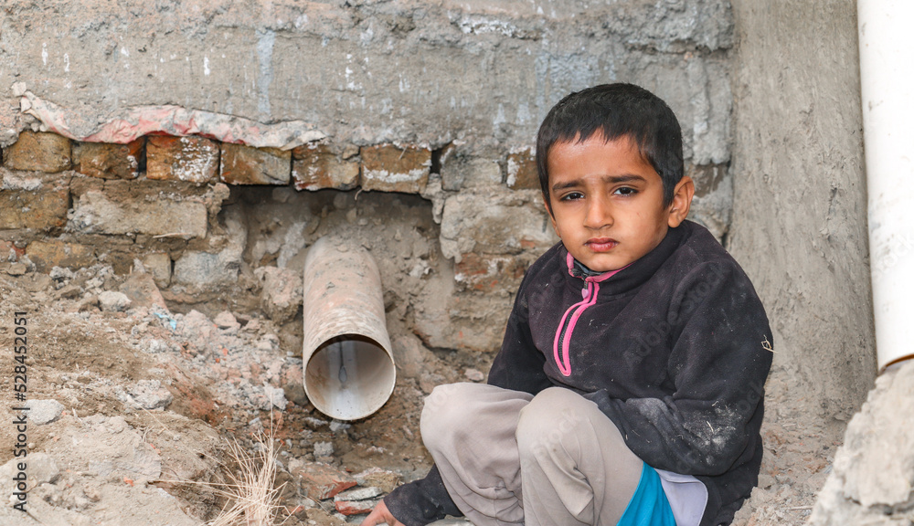 a child with a sad expression cause of flood and homelessness situation ...
