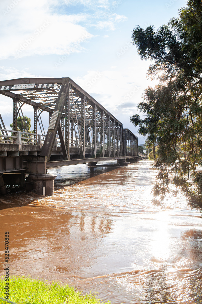 Dangerous flood water rising up bridge pylons after rain Stock Photo ...