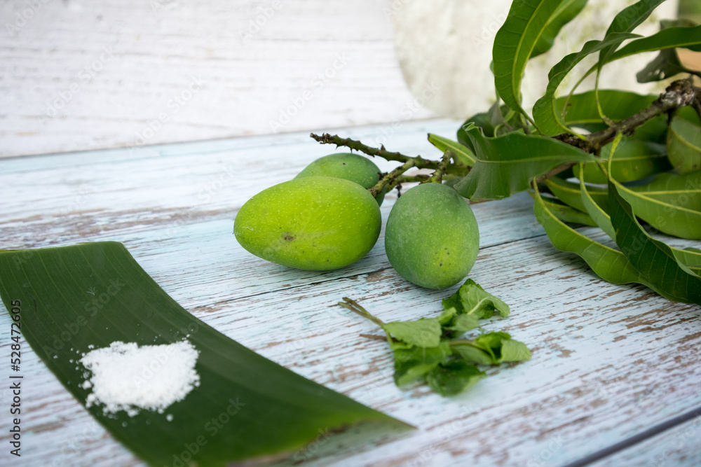 Some raw mango or kaccha aam with some ingrediants like chilli, salt ...
