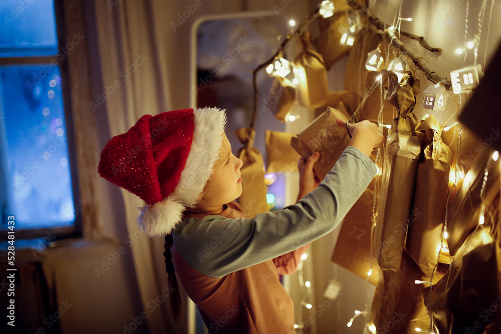 Magic photo. child with an advent calendar in eco-rust paper and ...