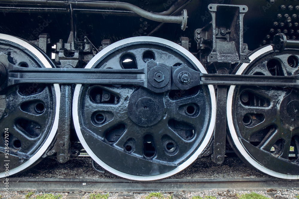 Steam locomotive wheels and connecting rods on a vintage train, daytime ...