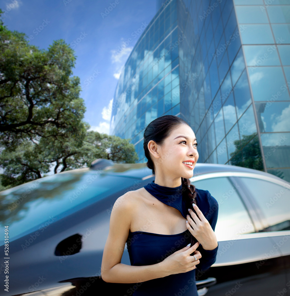 Beautiful woman driving a luxury car and using electric cars to save ...