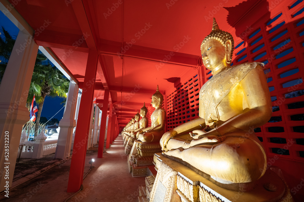 Several golden statues of Buddha statues in meditation posture are ...