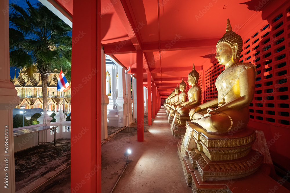 Several golden statues of Buddha statues in meditation posture are ...