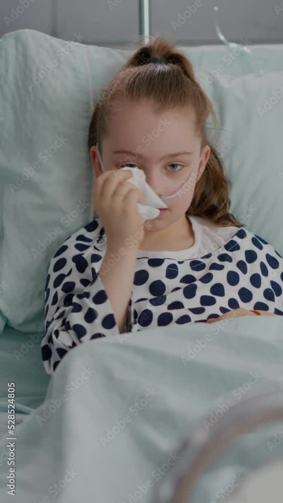 vertical video: Portrait of sick vulnerable alone little child looking ...