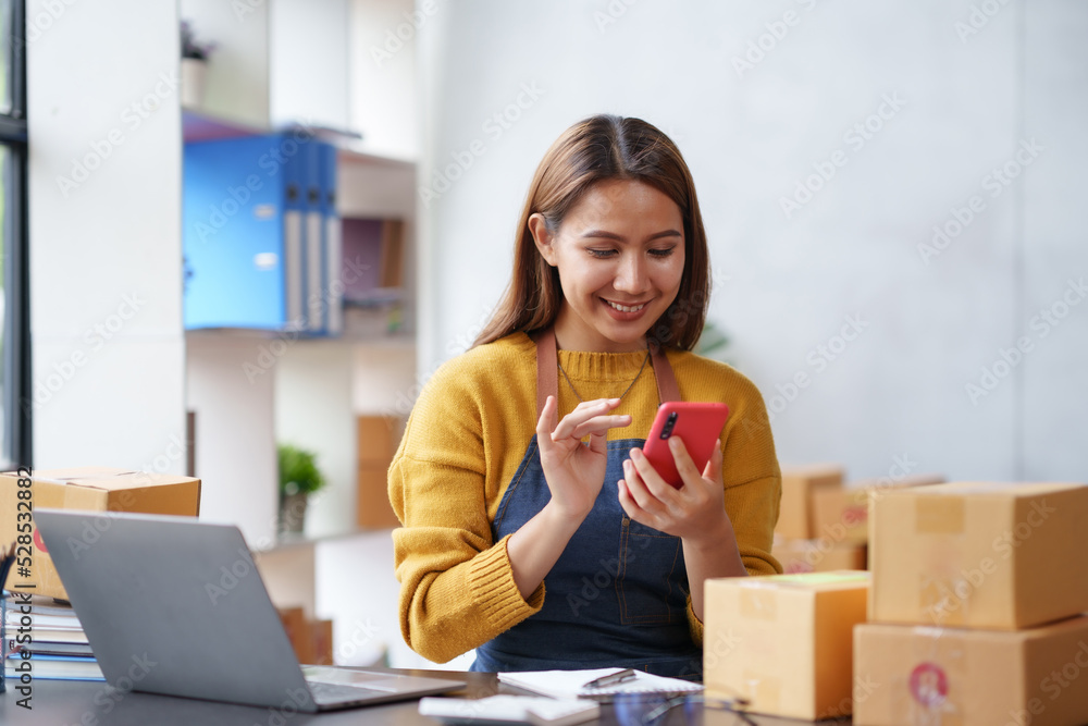 Online business owner Asian woman answer phone chat with customers and ...