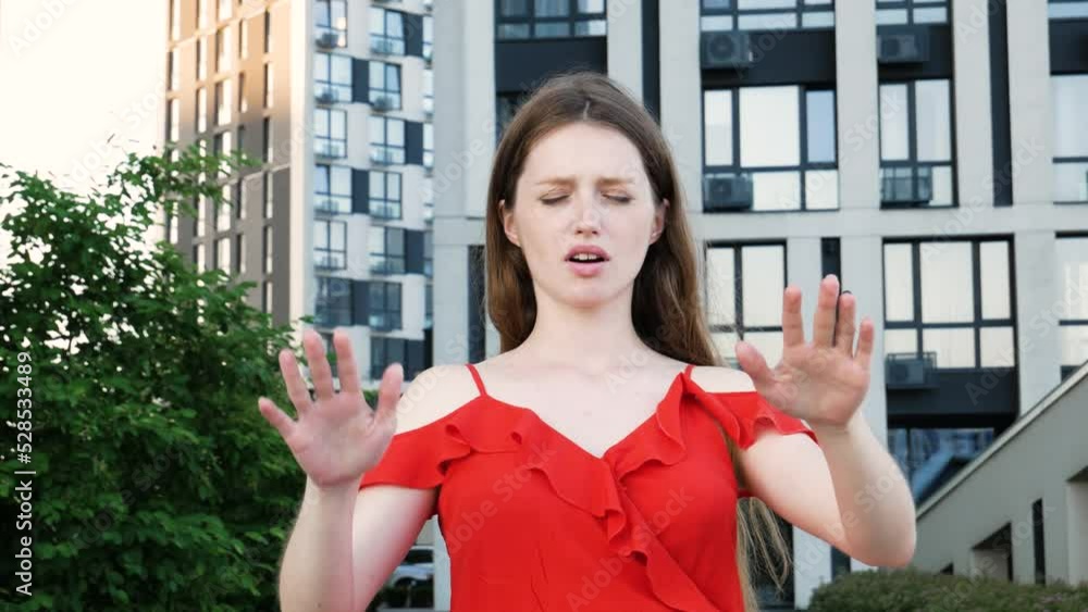 Blind woman with long hair wearing red elegant dress walking with ...