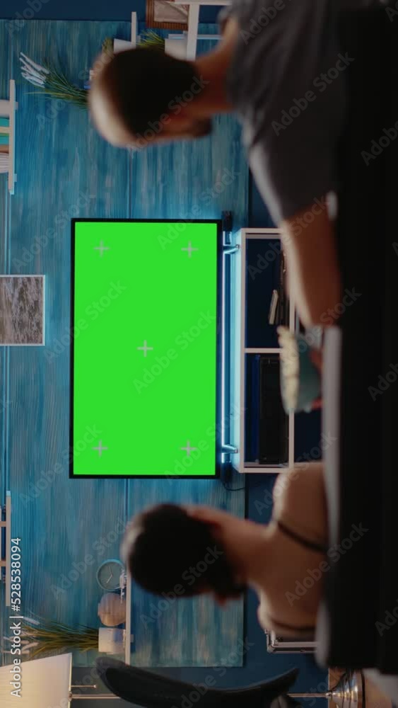 Caucasian people watching green screen layout on tv display in living ...