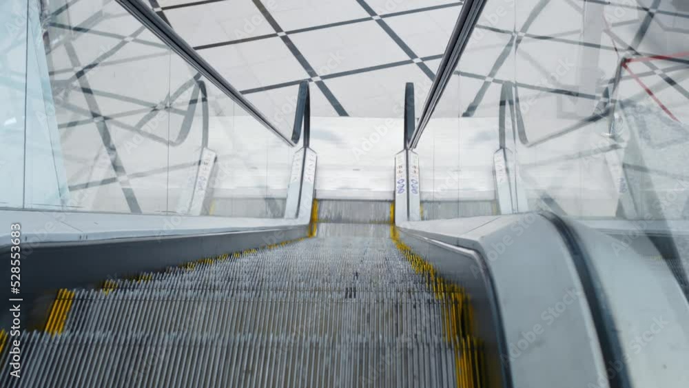 Automatic ladder that rises up. Metal staircase escalator in a shopping ...