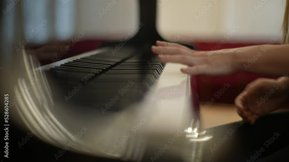 Close-up hands of unrecognizable female pianist opening cover of grand ...
