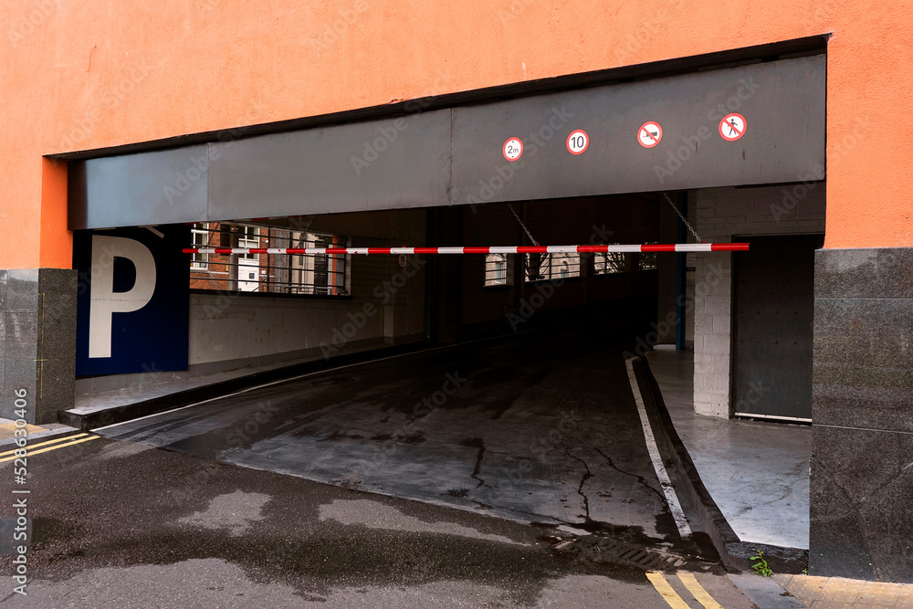 Underground car park entrance in a street of a residential or office ...