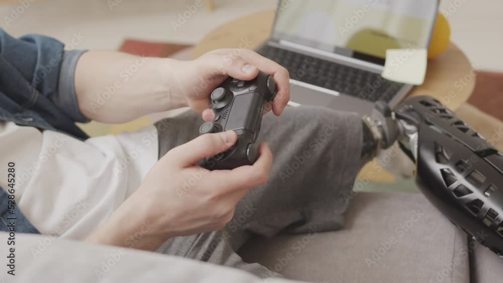 Slowmo of unrecognizable man with prosthetic leg operating wireless ...
