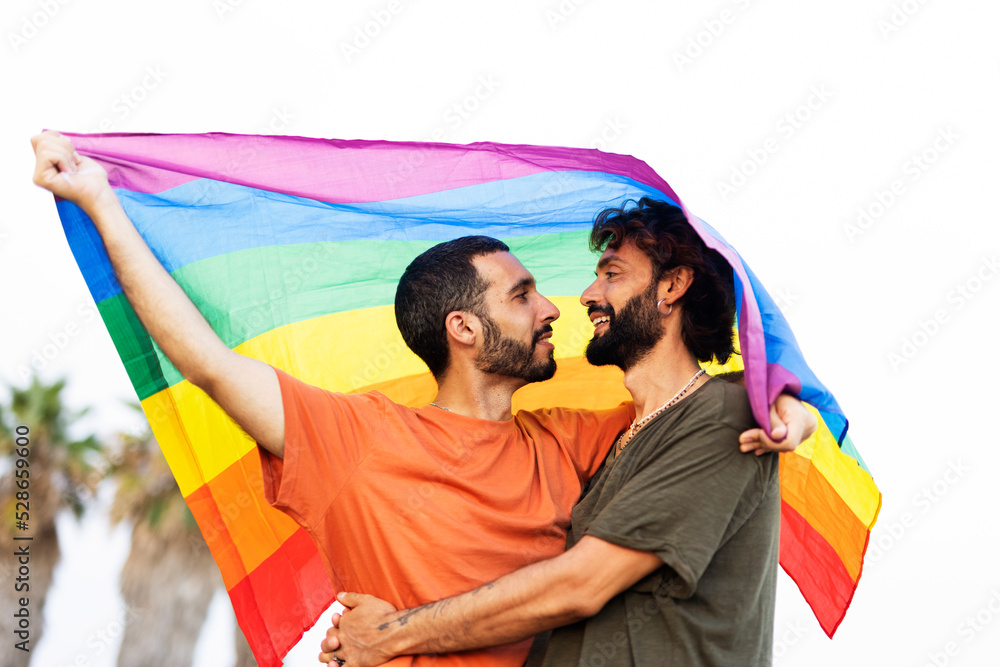 Happy couple with a pride flag. LGBT community. Stock Photo | Adobe Stock
