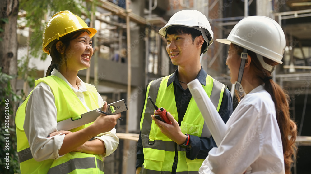 Team of civil engineer wearing safety helmet and yellow vests planning ...