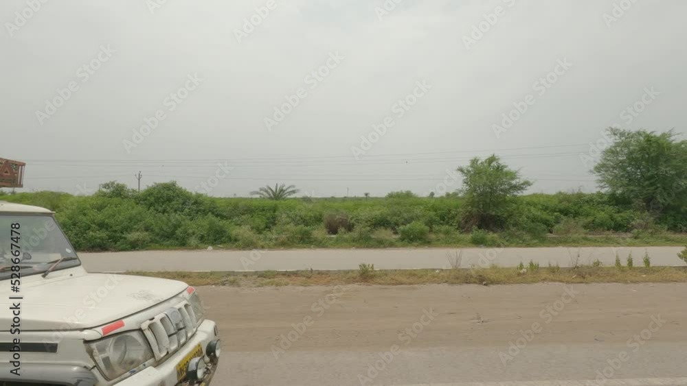 Side angle of a vehicle overtaking light commercial vehicle passing ...