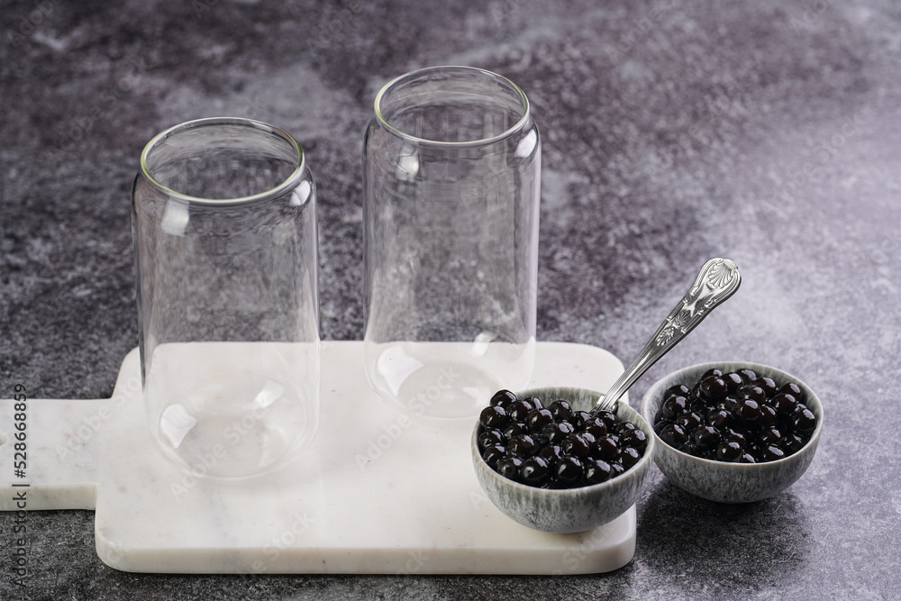 Cooked tapioca pearls for trendy bubble boba ice tea in two small grey ...
