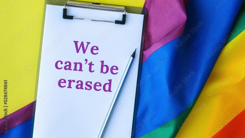 4k zoom in out Rainbow flag with text WE CANT BE ERASED message paper ...