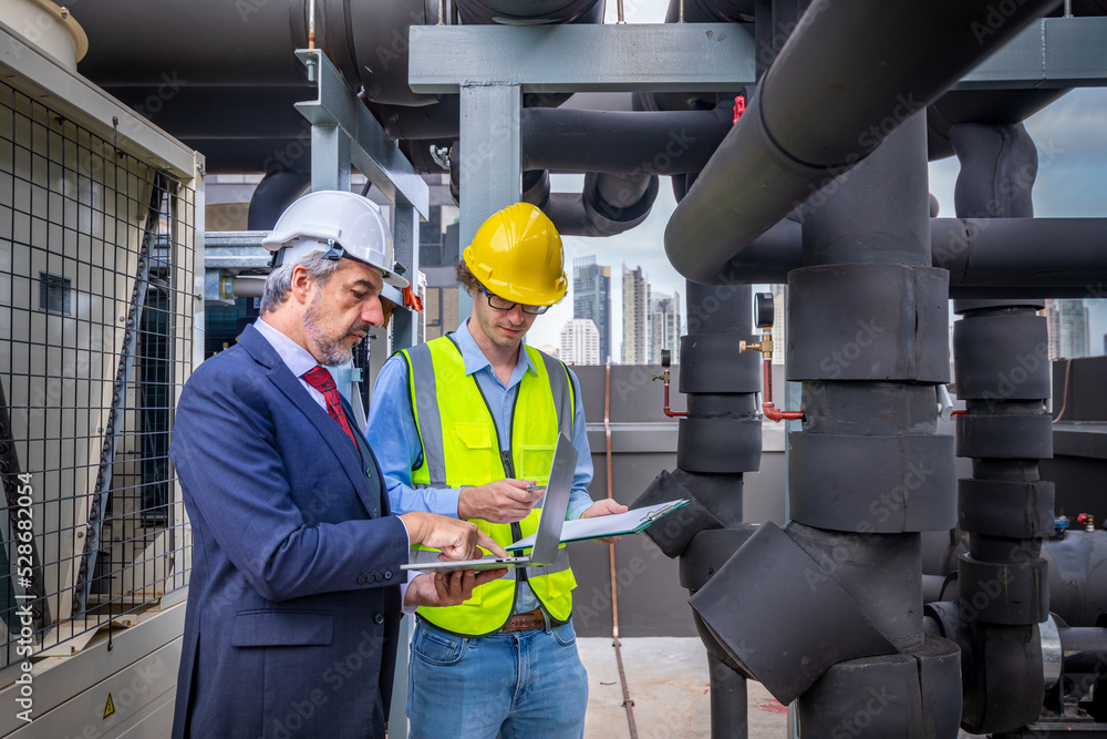 engineer under checking the industry cooling tower air conditioner is ...