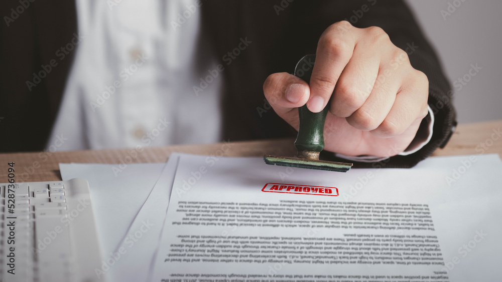 Approved stamp concept. Close-up Of A Person's Hand Stamping in paper ...