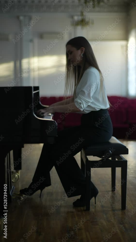 Full length vertical shot of gorgeous female pianist with long hair ...