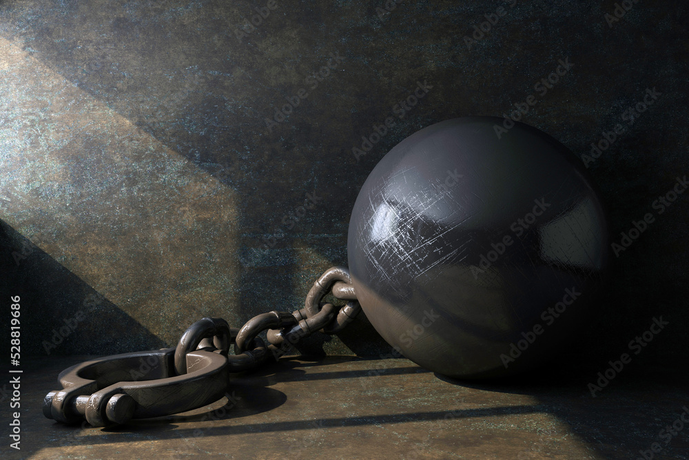 leg shackles with a ball illuminated by a beam of light in a dungeon ...