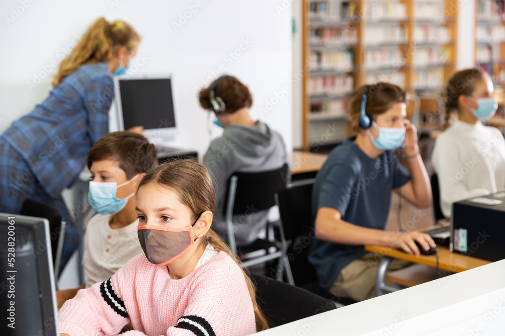Preteen boy and girl in protective mask learn to solve problems on ...