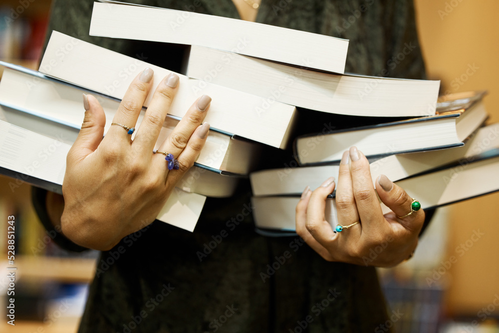 Woman with books in a library for reading, study project or research at ...