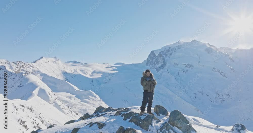 Aerial orbit motion of Young asian man standing on top of the famous ...