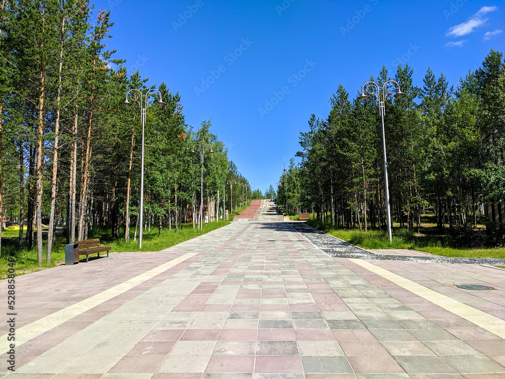 Noyabrsk, Russia - July 6, 2022: View of the sidewalk in the city park ...