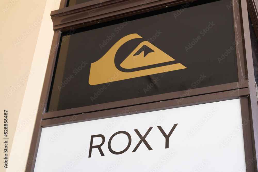 roxy and quiksilver logo sign and brand text on store facade clothing ...