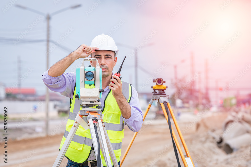 Surveyor engineer wearing safety uniform ,helmet and radio ...