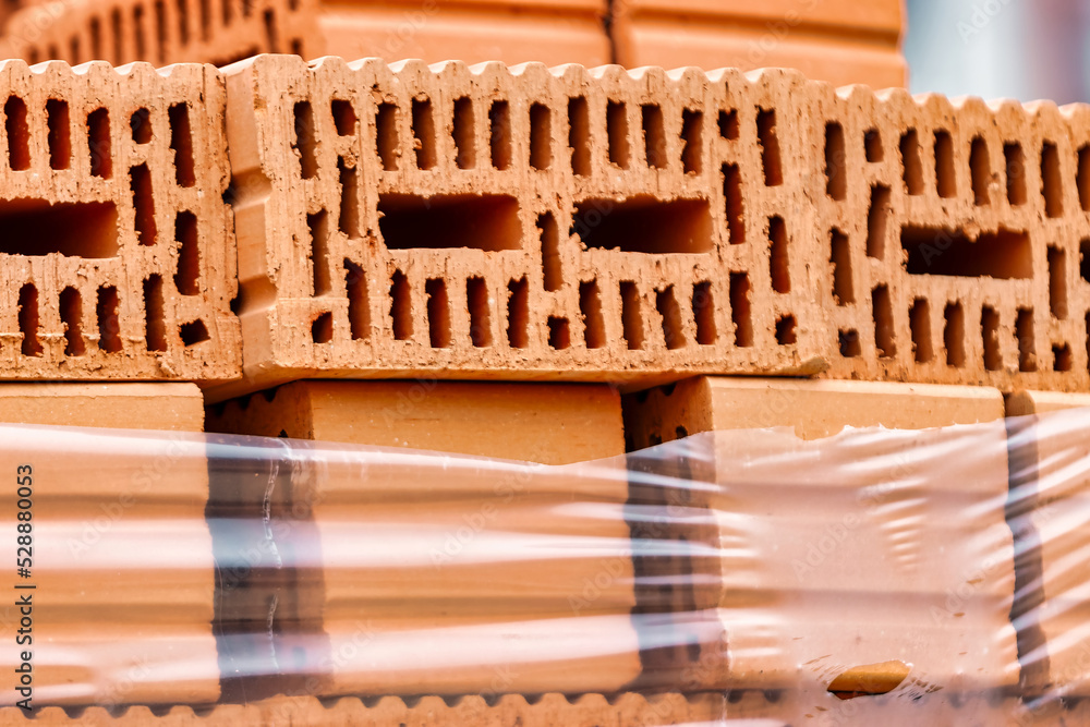 Red ceramic bricks at the construction site. Keramoblock. Hollow brick ...