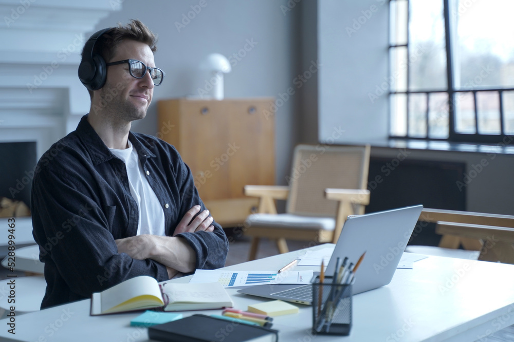 Positive German man bank employee sitting at workplace at modern home ...
