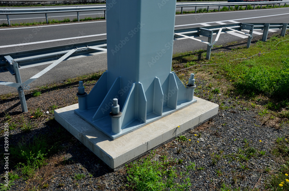gray steel column, beam, bolted with massive large screws to concrete ...
