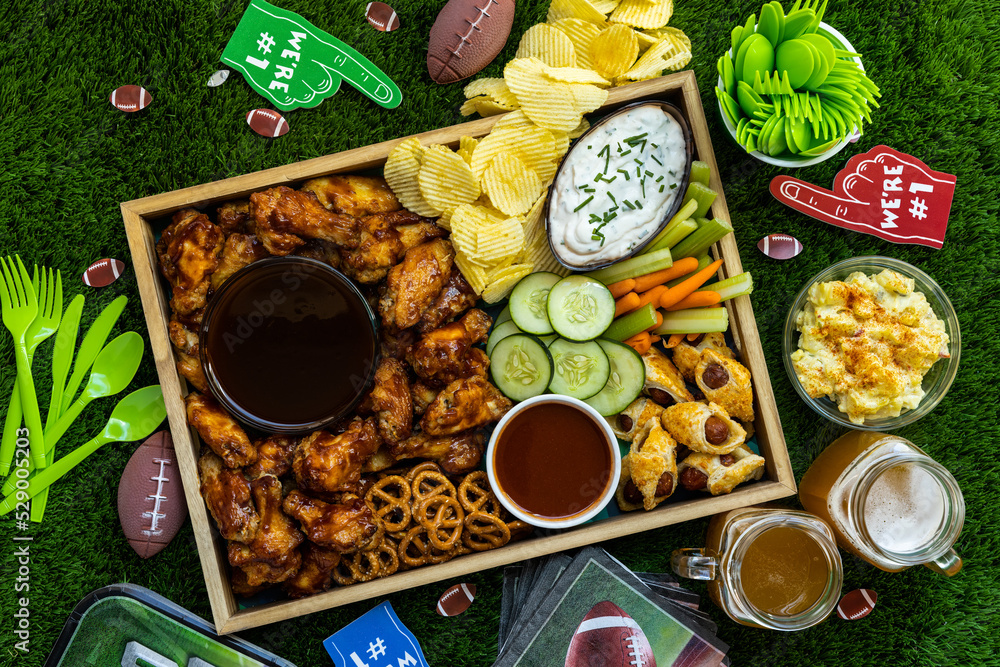 Overhead shot of football game day tailgate party food and snacks with ...