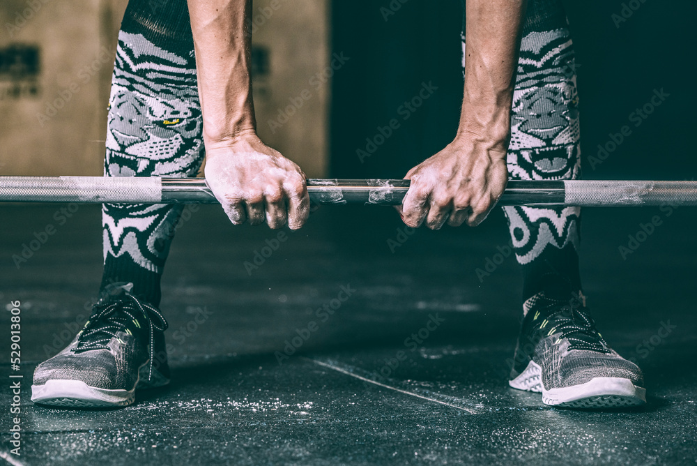 Poster woman legs and hands holding and lifting a bar weights training ...