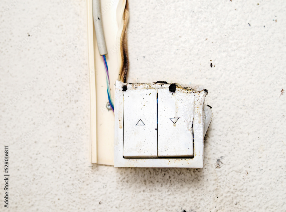 Melted light switch after a house fire. Front view of light regulator ...
